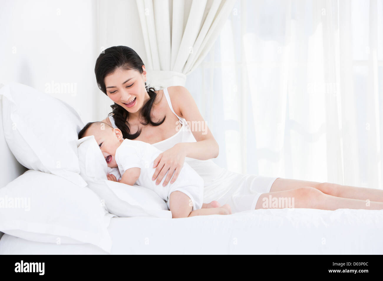 Happy mother and baby having fun Stock Photo - Alamy
