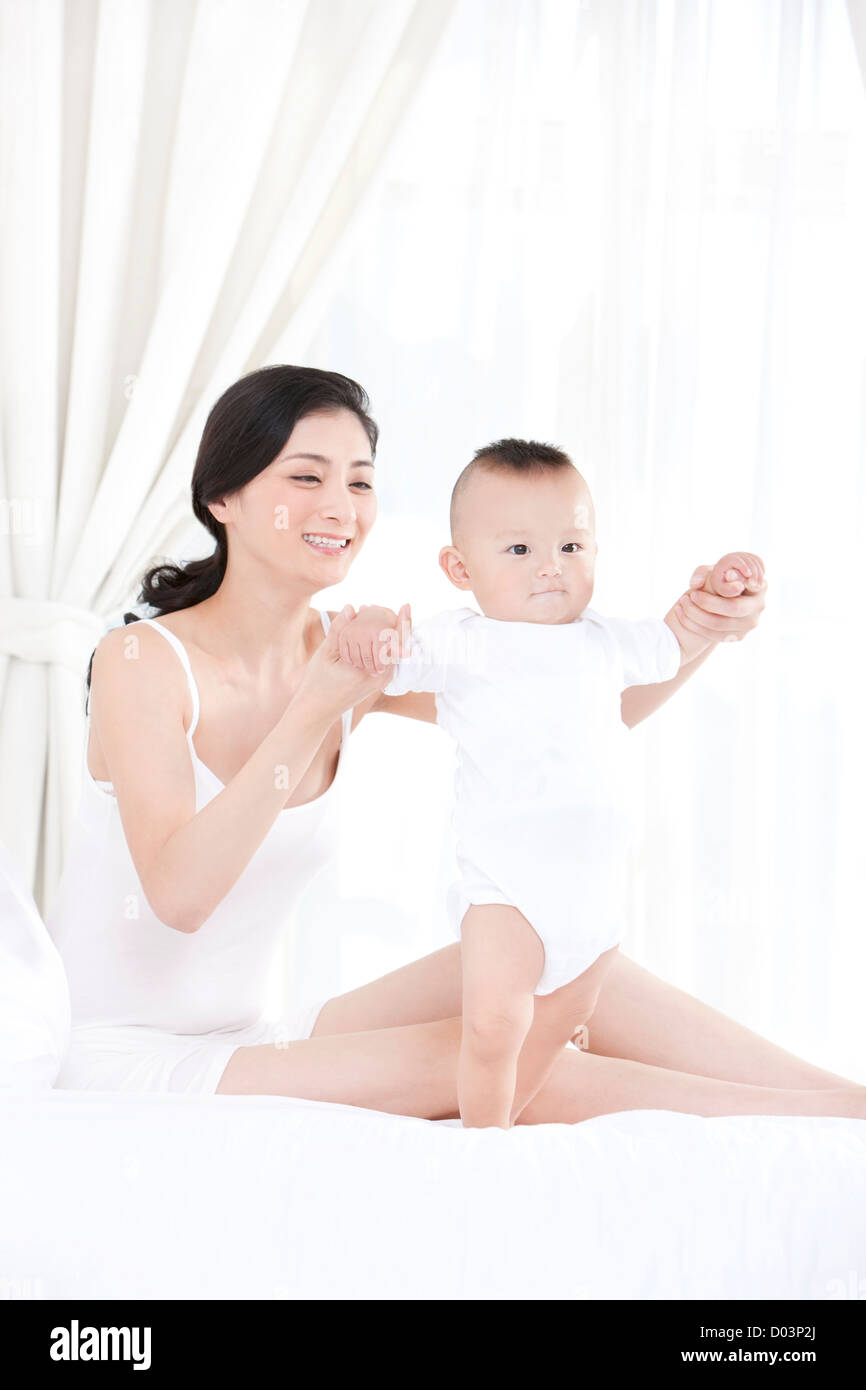 Sweet moment between mother and baby Stock Photo - Alamy