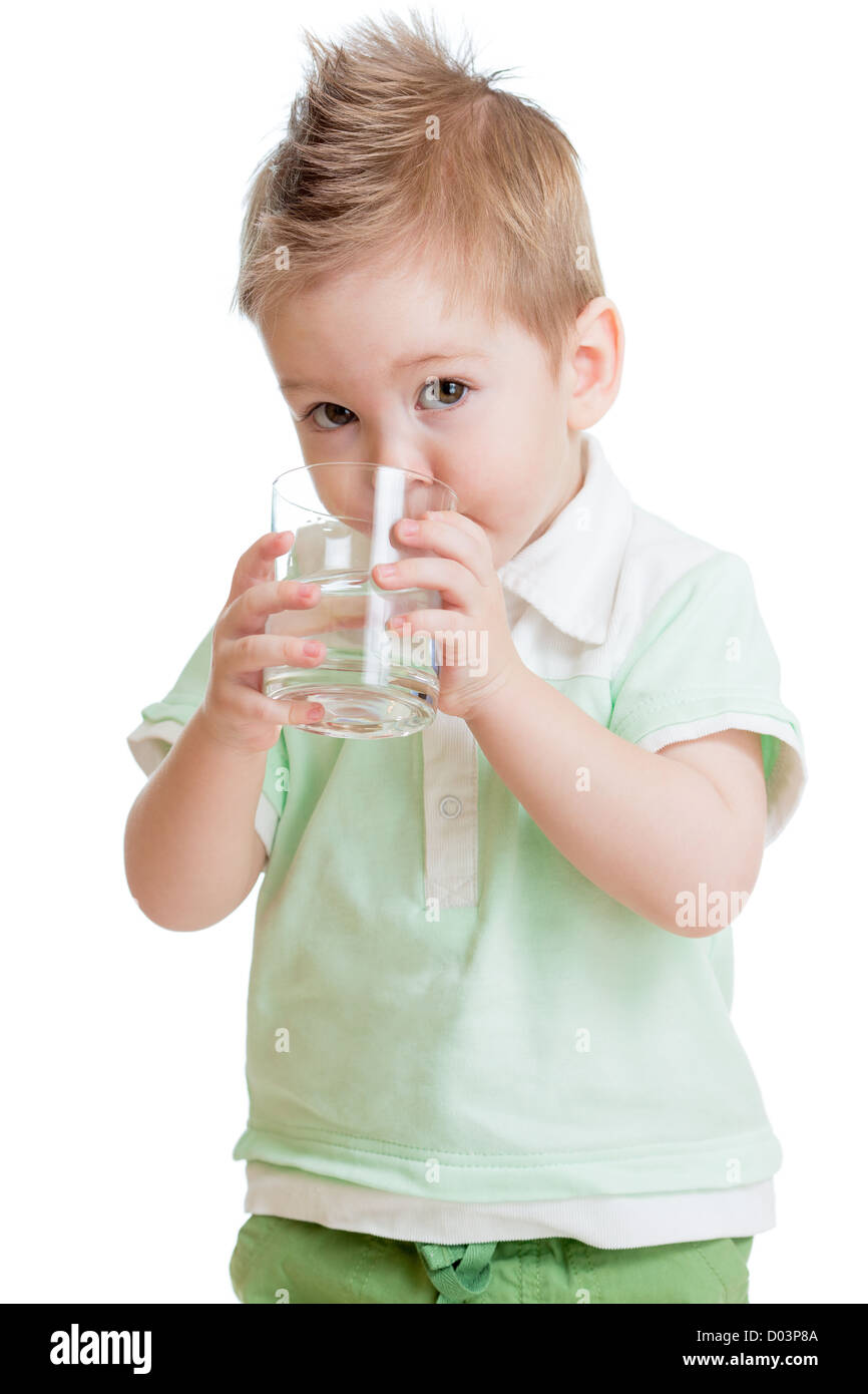 Little kid or child drinking water from glass isolated on white. It is ...