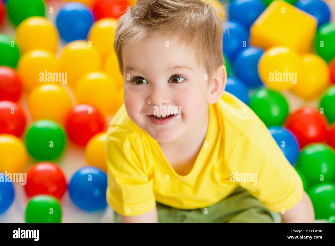 Cute kid or child playing colorful balls top view Stock Photo - Alamy