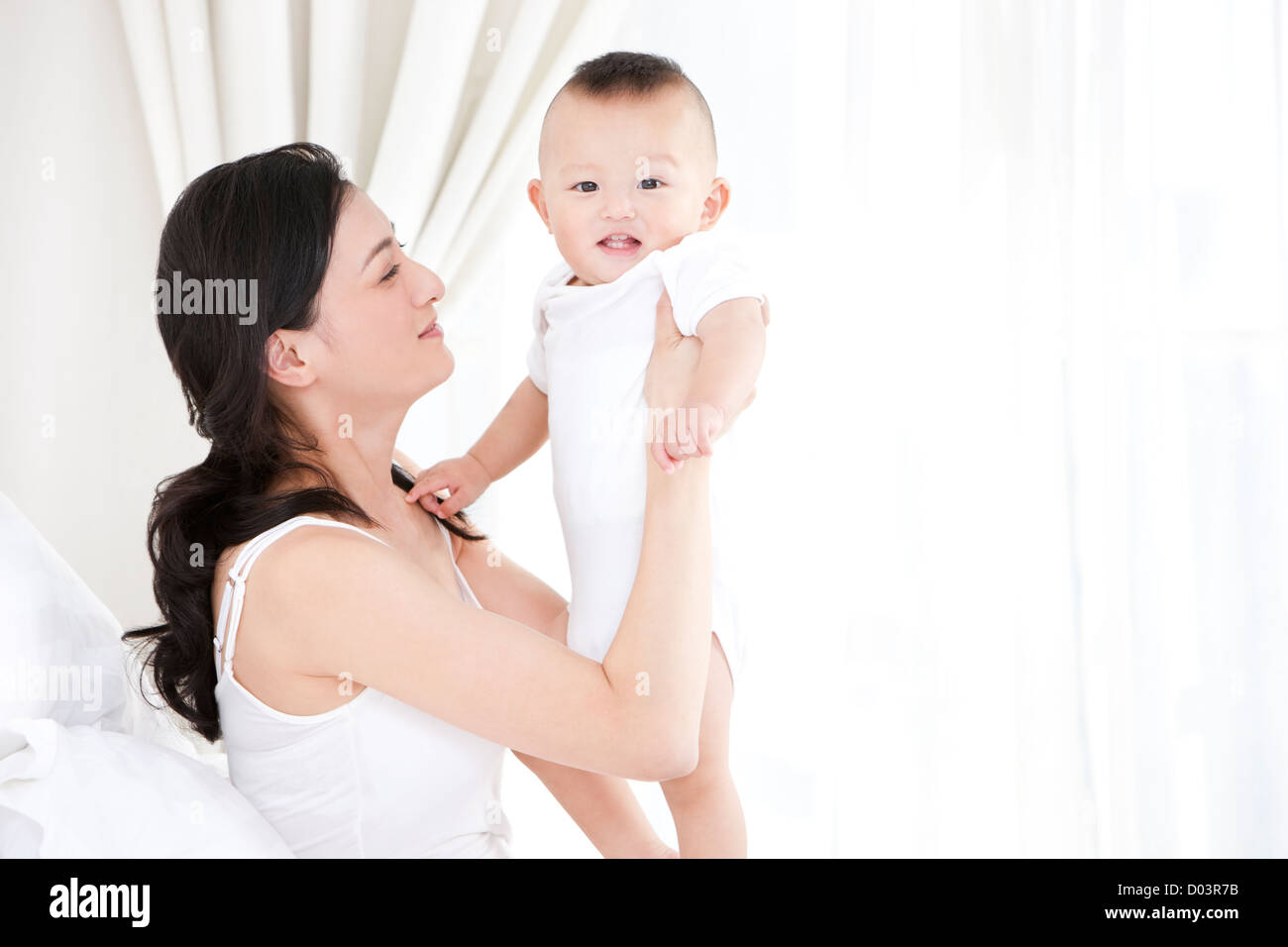 Mother loving cute little baby Stock Photo - Alamy