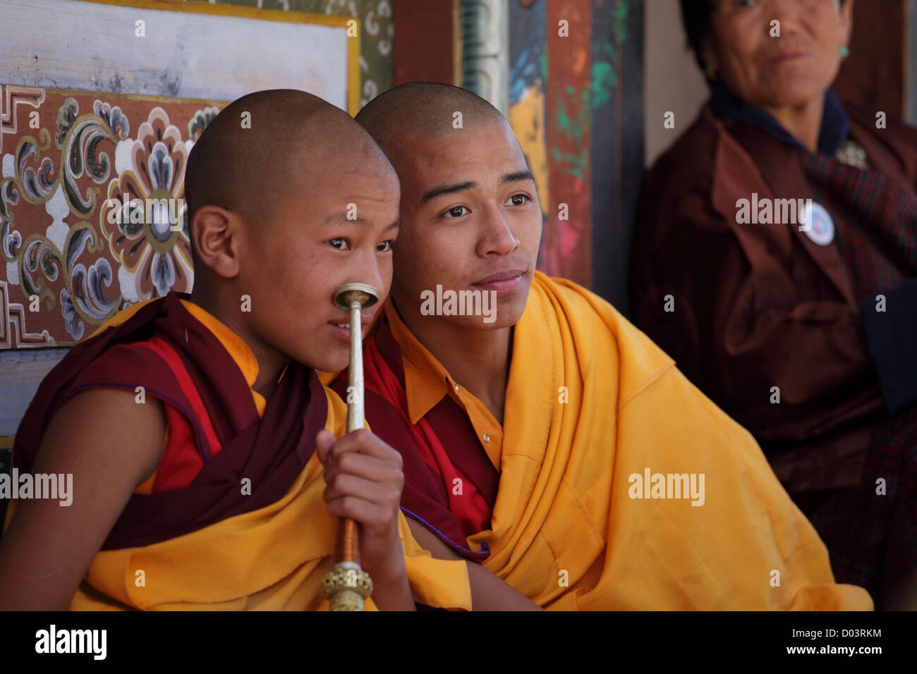 Two young monks watching their fellow monks dance as the picture was ...