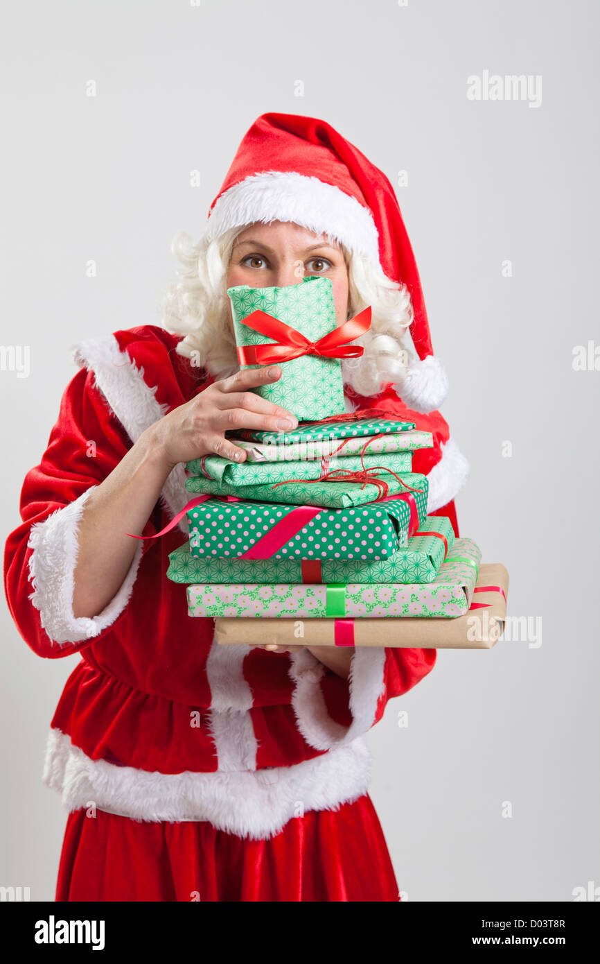 Studio portrait shot of Santa Claus helper elf holding and peering from ...