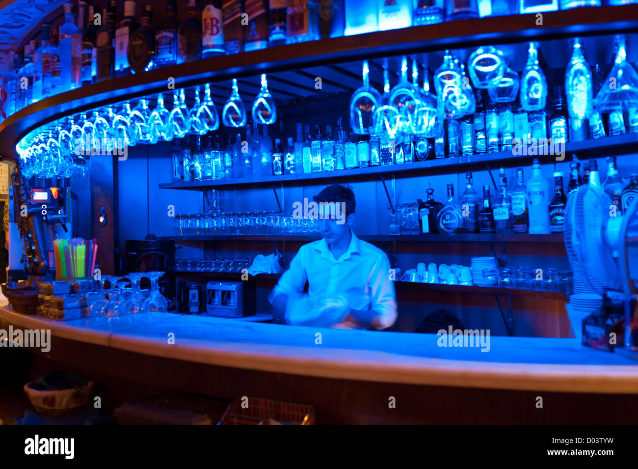 Bartender under blue lights in a bar in Istanbul Stock Photo - Alamy