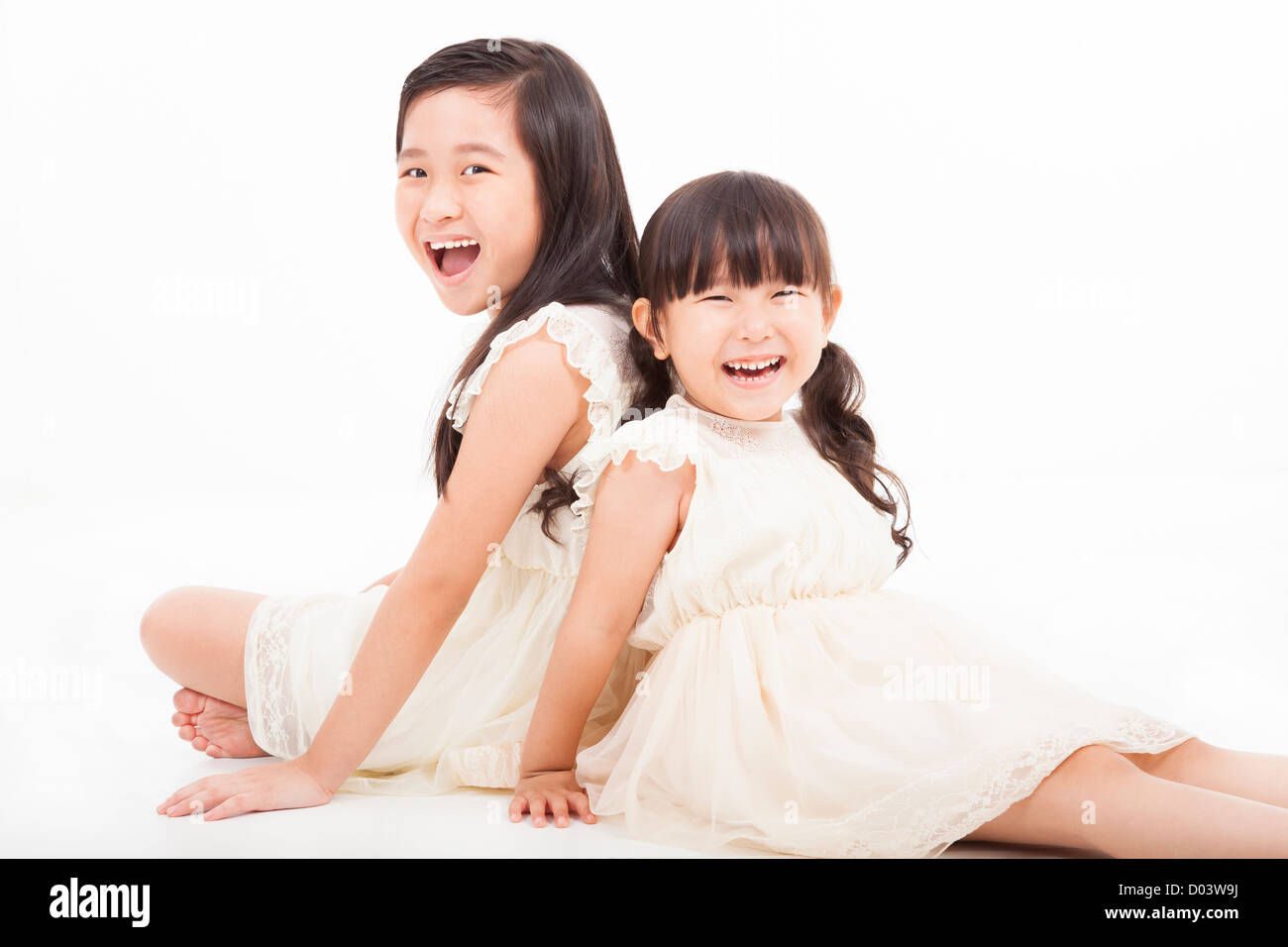 happy girls sitting on the white background Stock Photo - Alamy