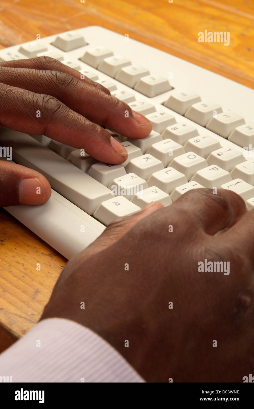 African man's hands typing on grey computer keyboard Stock Photo - Alamy