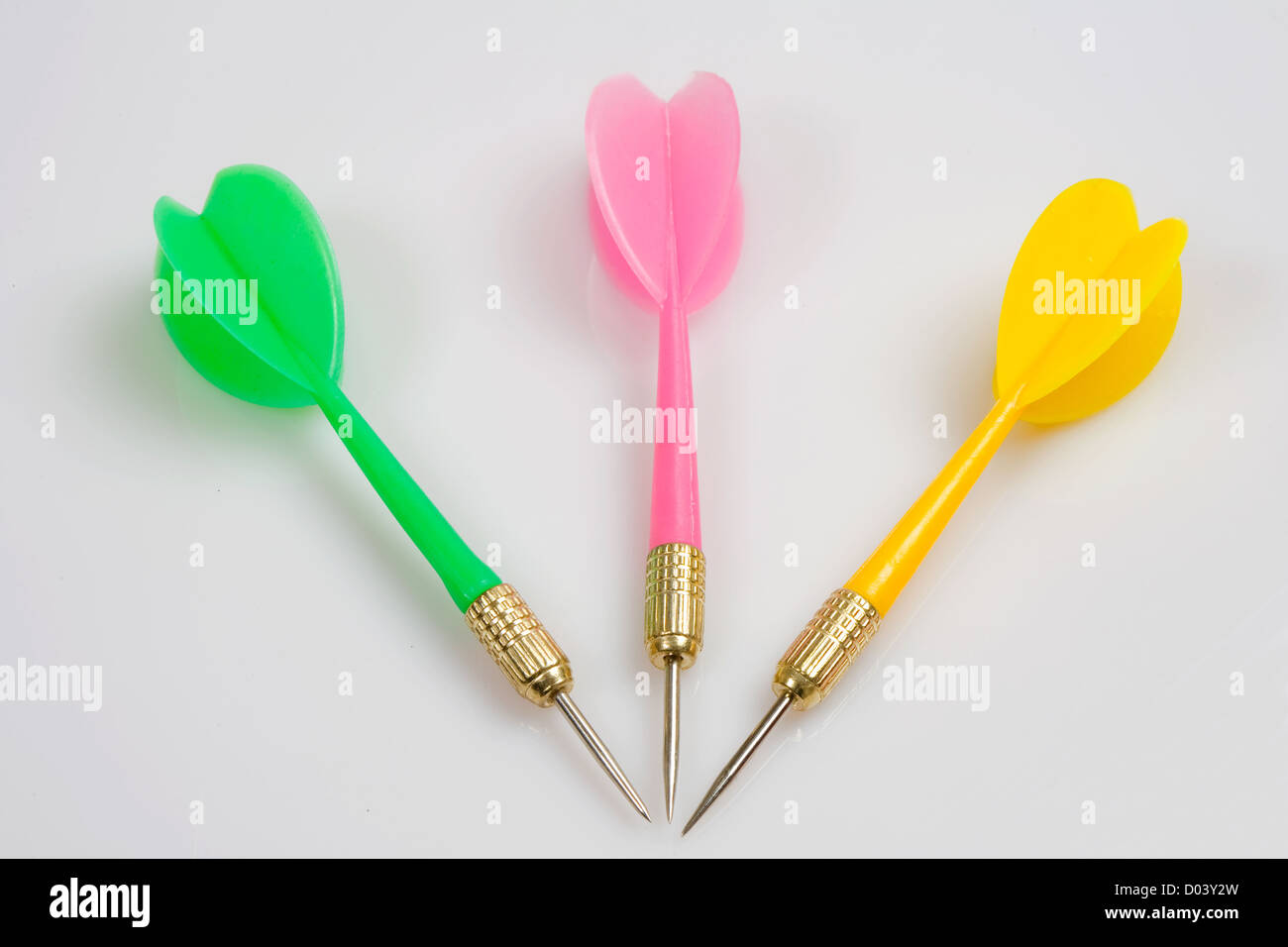 Photo of three darts arrow of different colors Stock Photo - Alamy