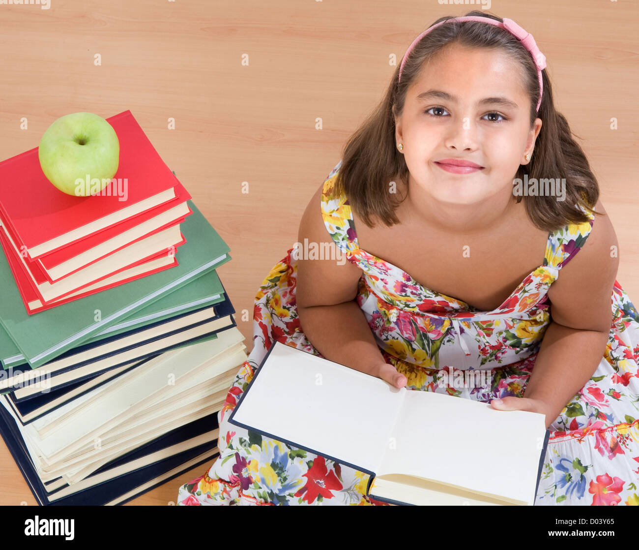 Adorable girl with many books reading Stock Photo - Alamy
