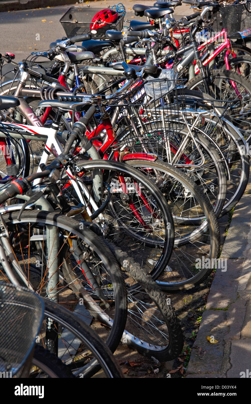 Close up of cycles bikes bicycles parked at a bike cycle rack in the ...