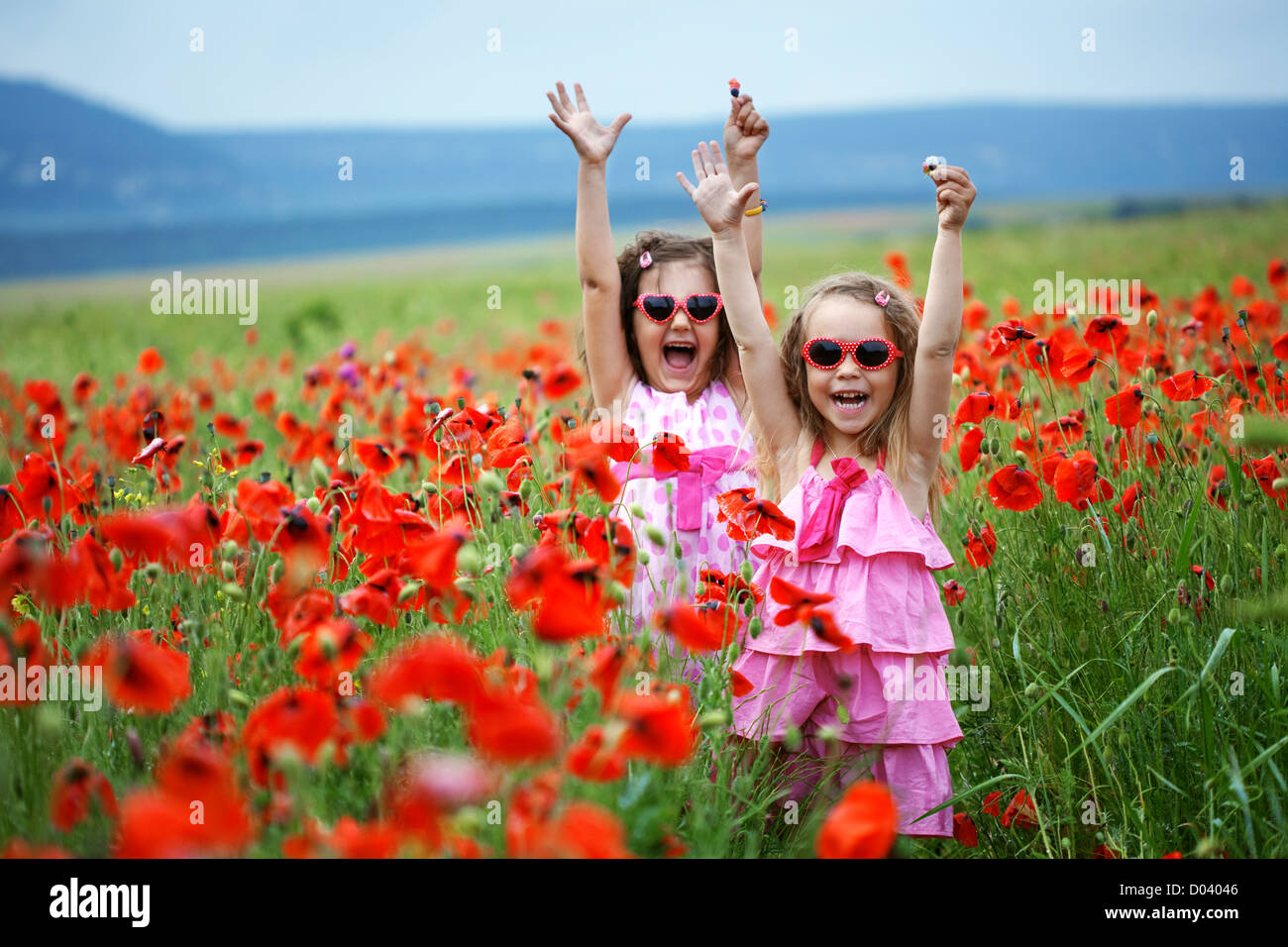 Cute children in poppy field Stock Photo - Alamy