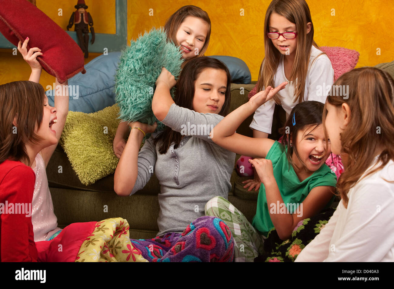 Group of little girls hitting each other with pillows Stock Photo - Alamy