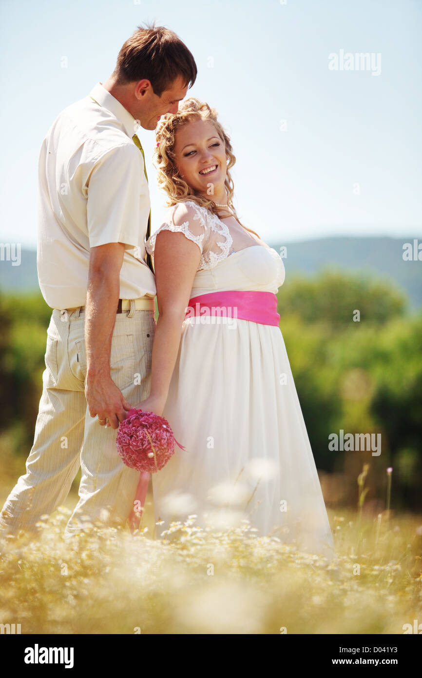 Wedding couple walking outdoor in field Stock Photo - Alamy