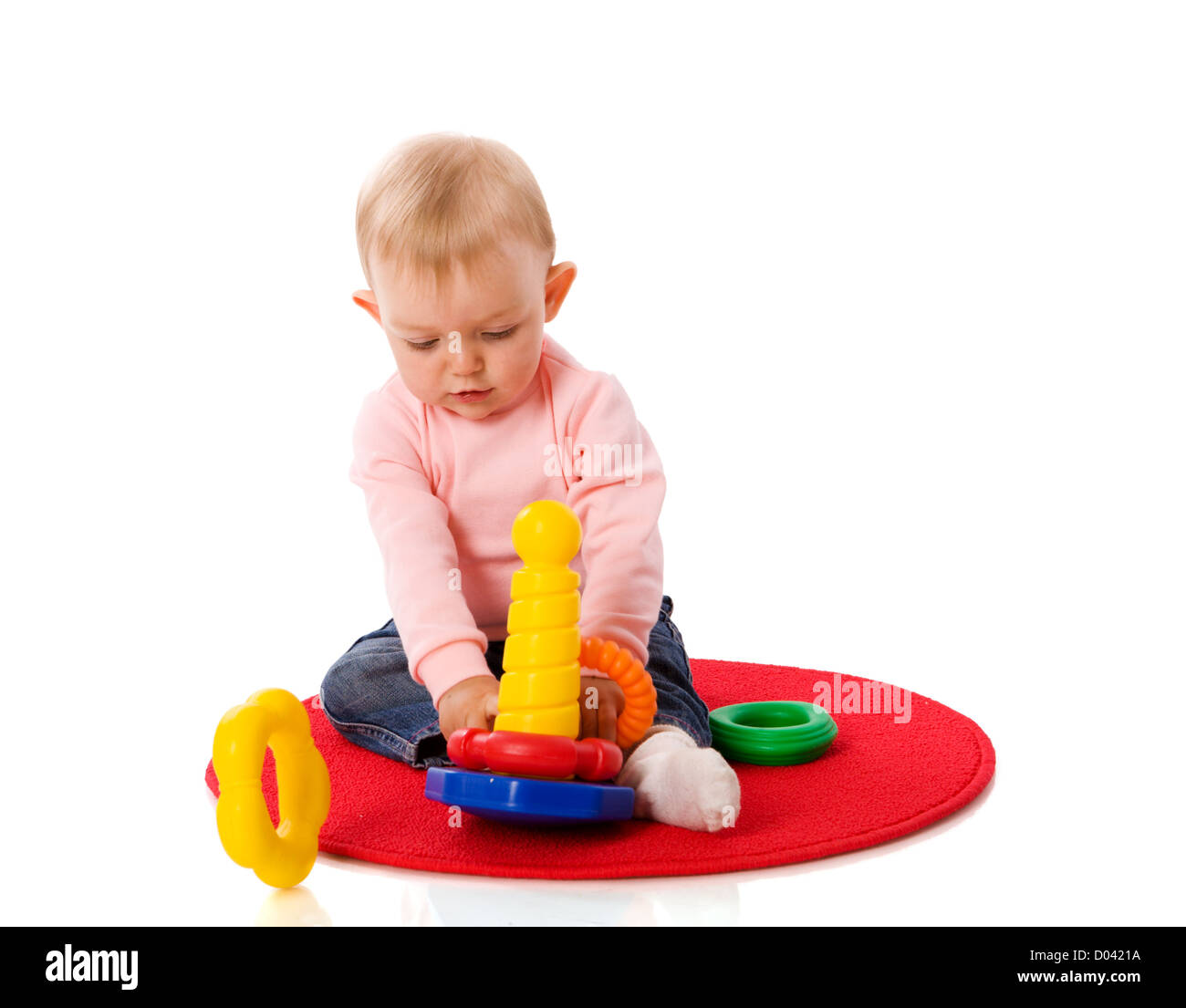 Toddler girl playing with pyramid isolated on white Stock Photo - Alamy