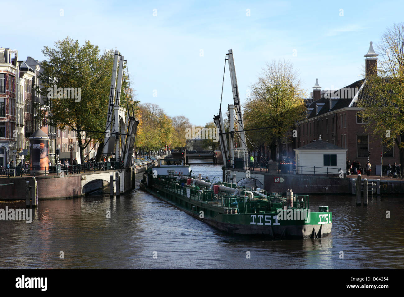 A barge passes through an opened bridge in central Amsterdam Stock ...