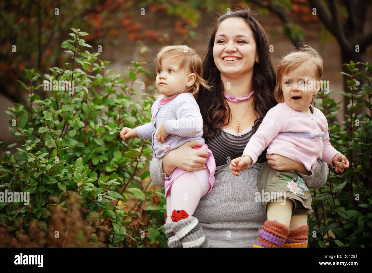 Mother with her twins Stock Photo - Alamy