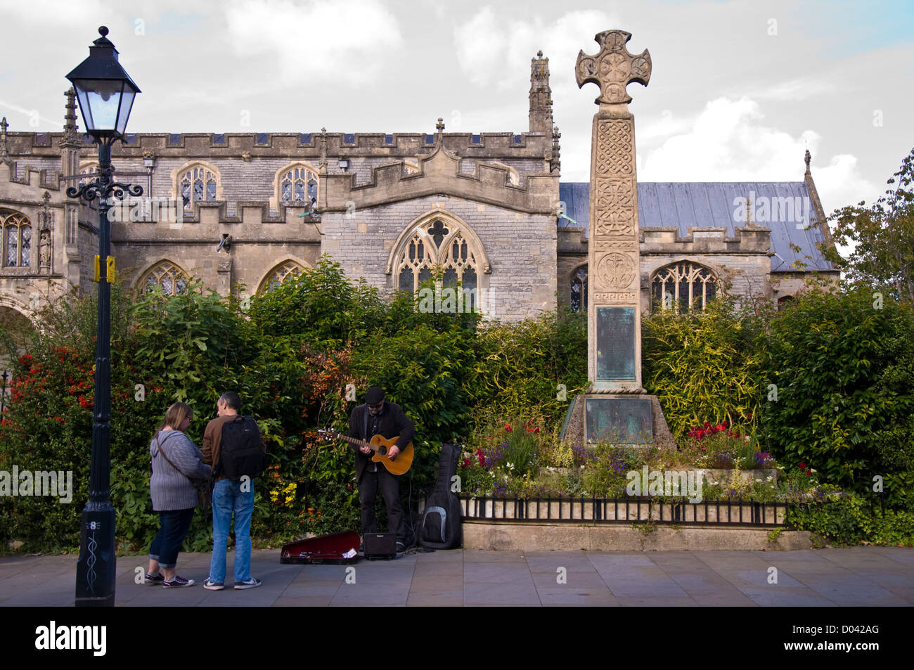 Busker plays by war memorial in front of Church of Saint John The ...