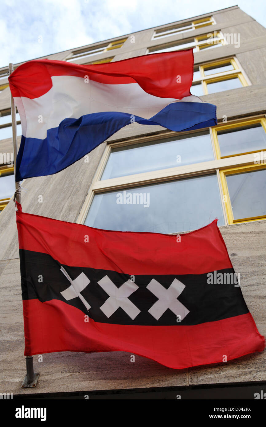 The national flag of the Netherlands flies above the flag of Amsterdam ...