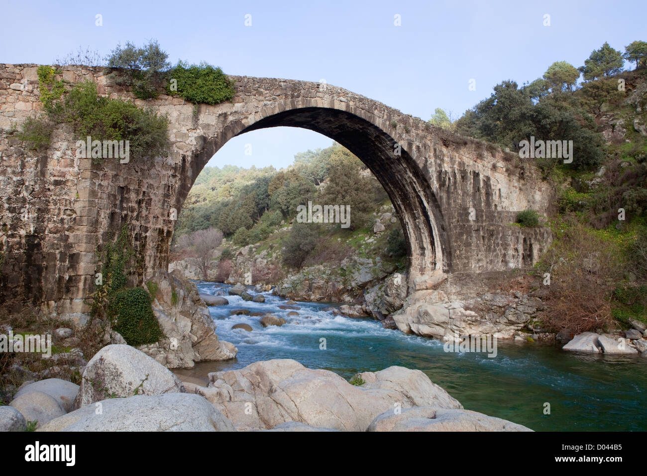 Big bridge with waterfall and green trees Stock Photo - Alamy