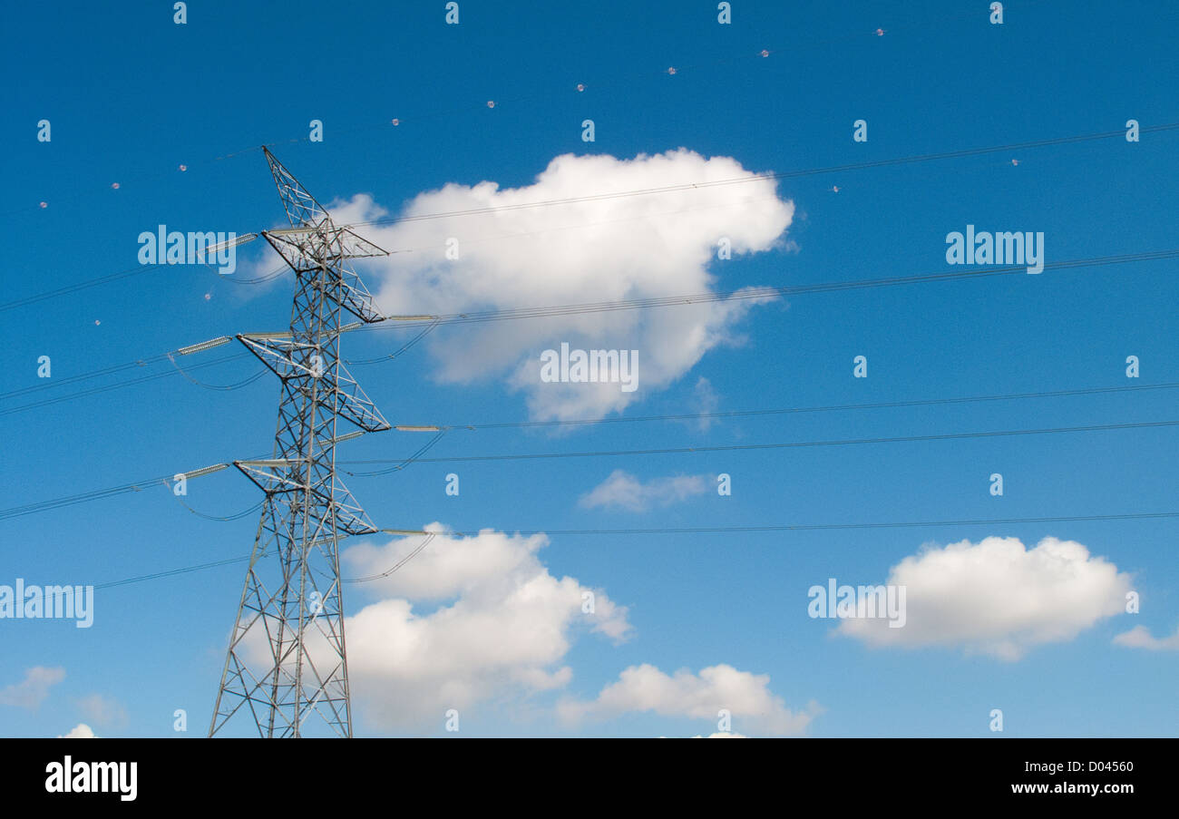 Power lines under a pretty blue sky Stock Photo - Alamy