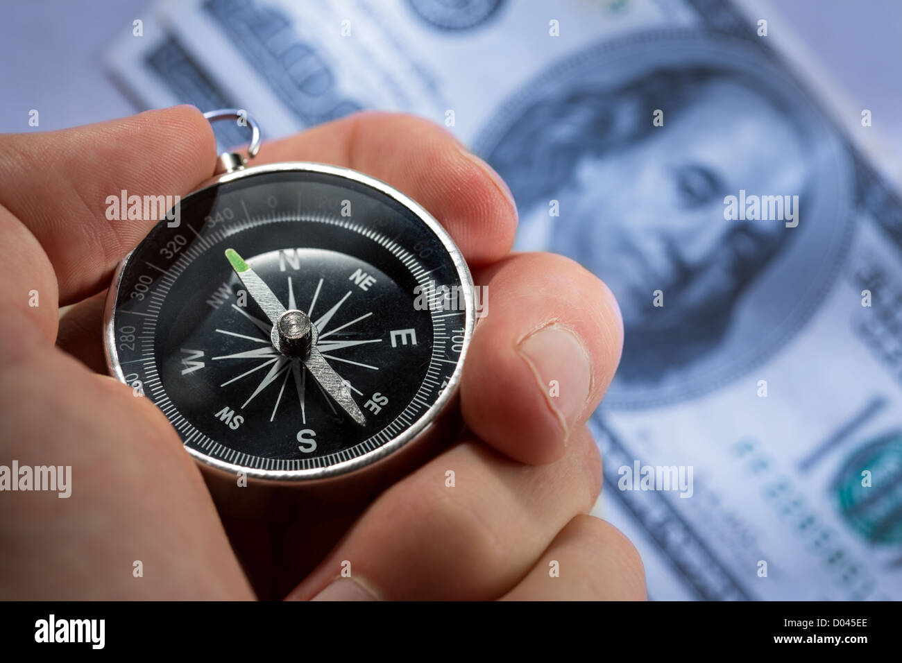 Hand holding silver black compass Stock Photo - Alamy