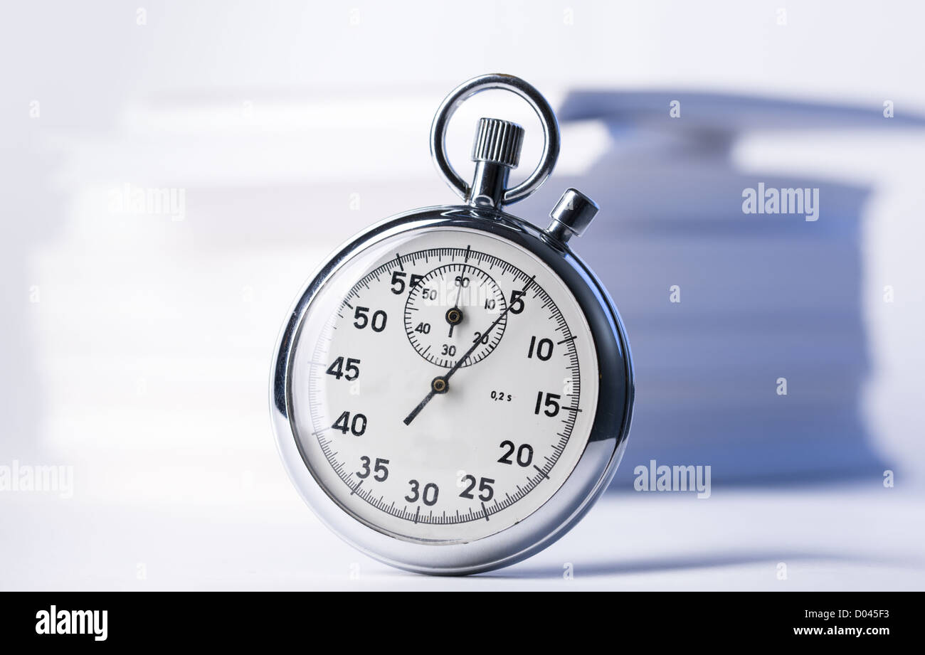 Pile of paper cards and stopwatch Stock Photo - Alamy