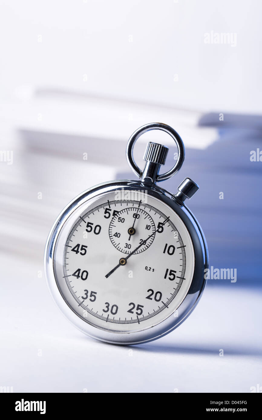 Pile of paper cards and stopwatch Stock Photo - Alamy