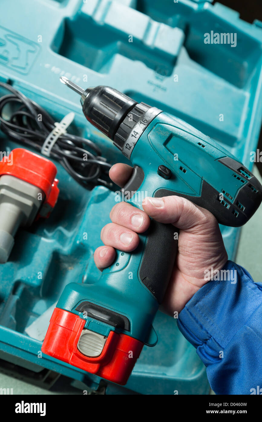 Male hand holding a screwdriver Stock Photo - Alamy