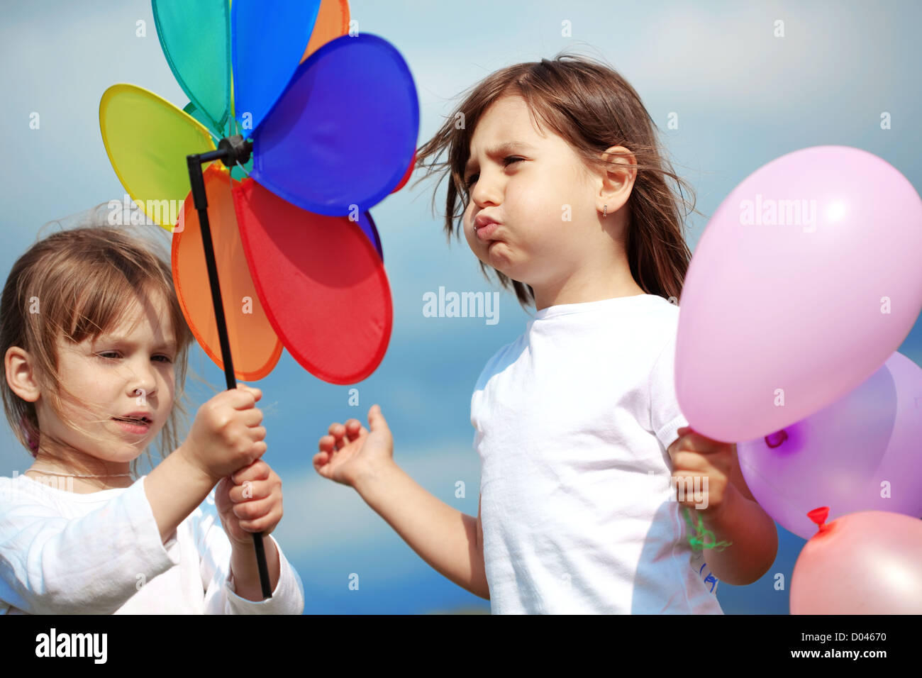 Cute happy children playing in spring filed Stock Photo - Alamy
