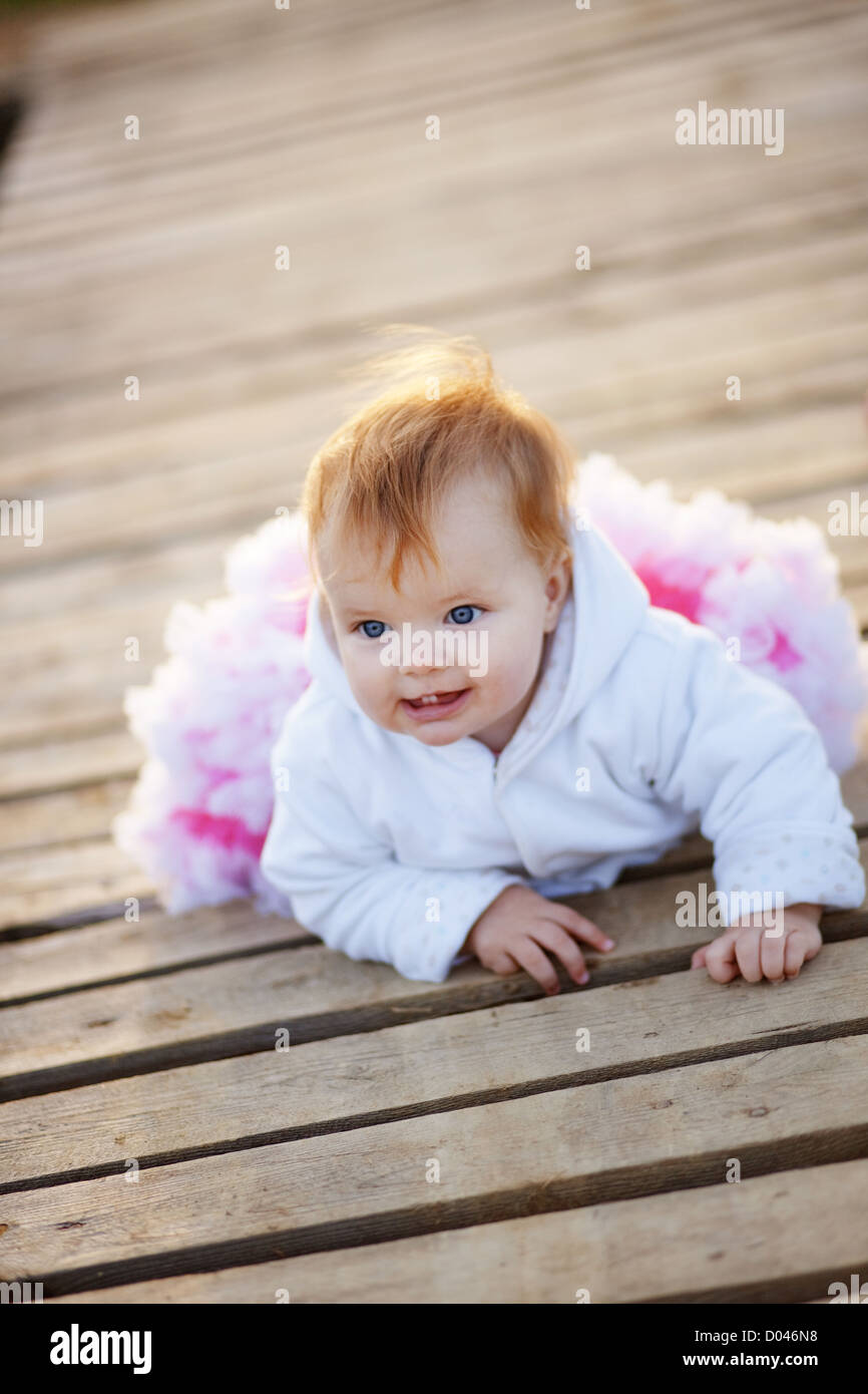 Adorable baby on wooden bridge Stock Photo - Alamy