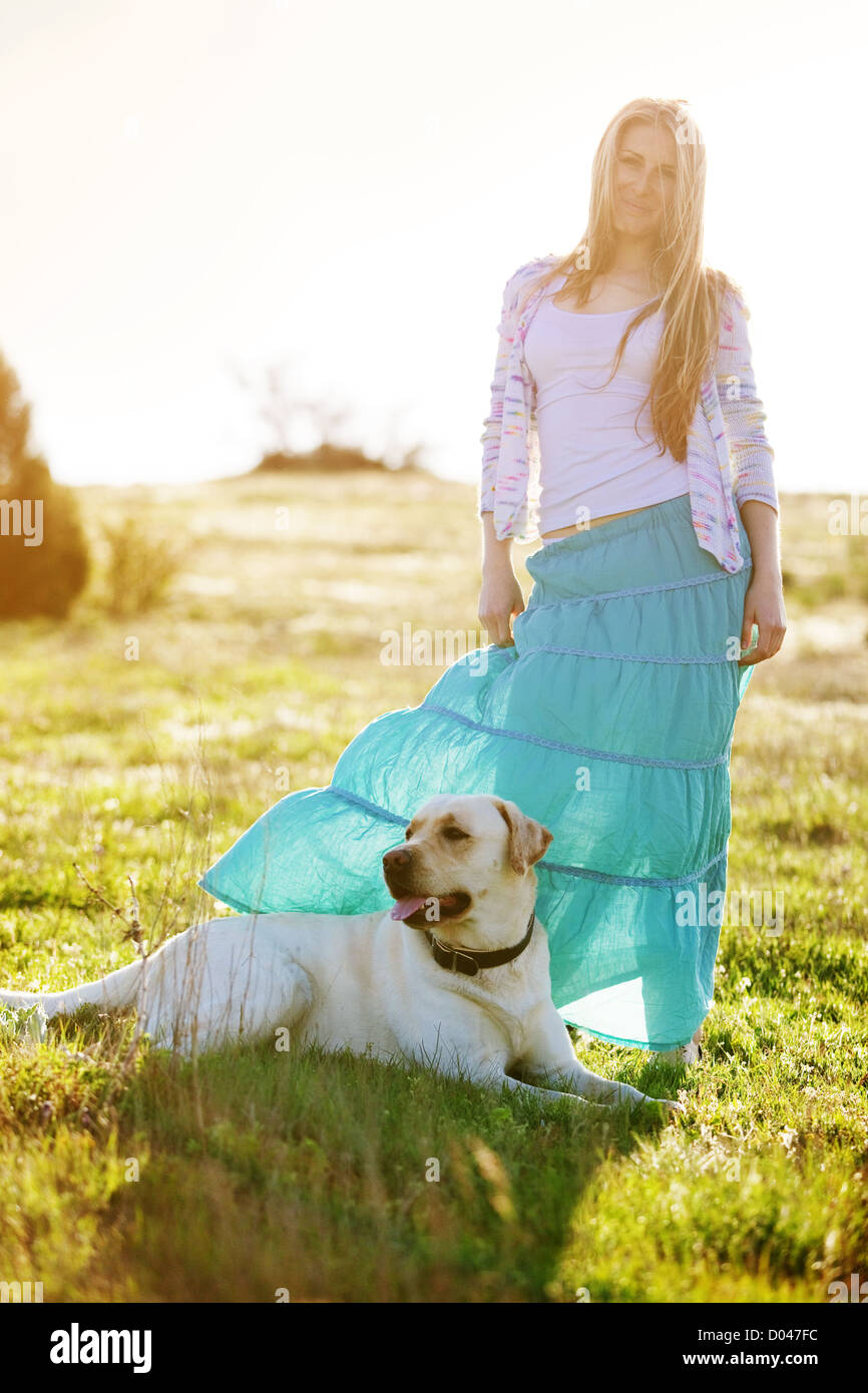 Young woman with ger dog resting at green field Stock Photo - Alamy