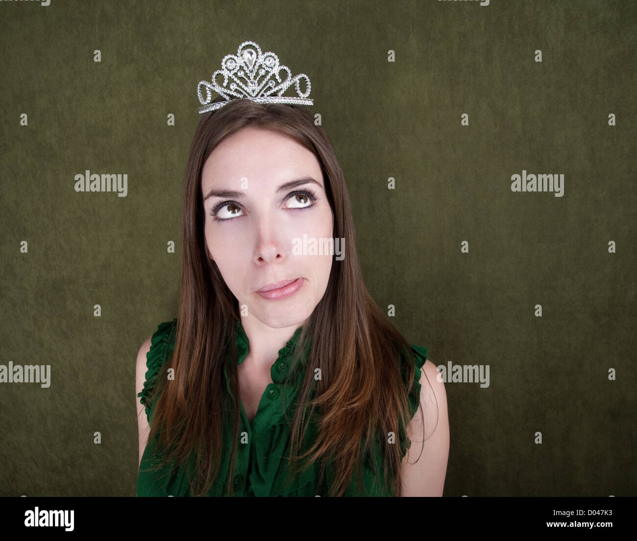 Pretty Caucasian woman with small crown daydreams Stock Photo - Alamy