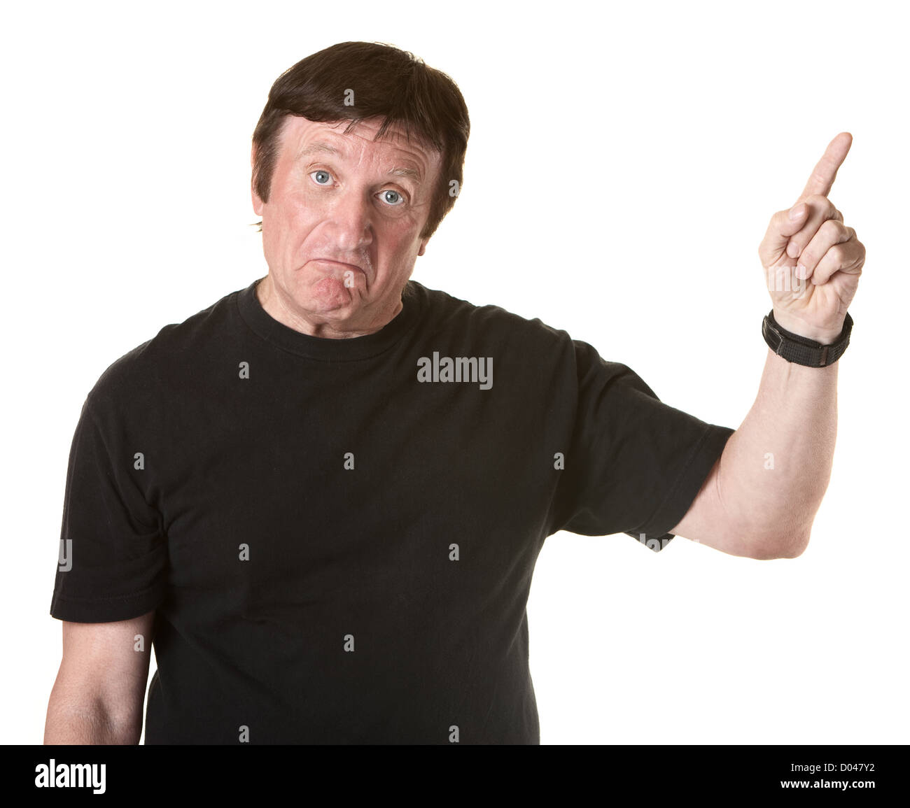 Mature Caucasian male on white background points index finger upward ...