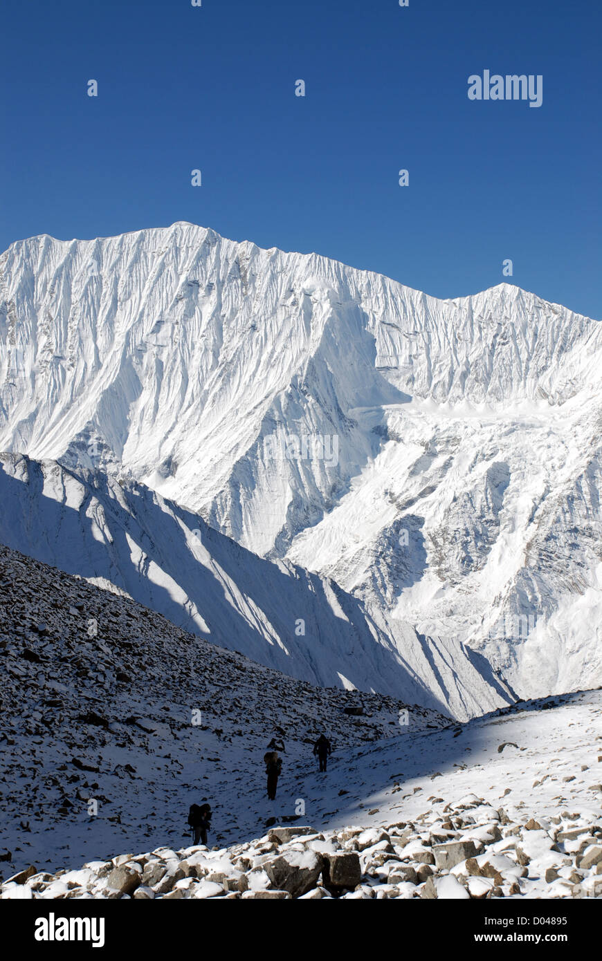 Trekkers on the snow covered Kang La pass in the Inner Dolpo region of ...
