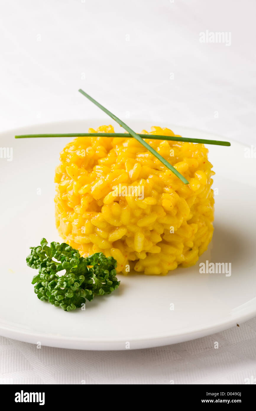photo of delicious yellow risotto with saffron on white isolated ...
