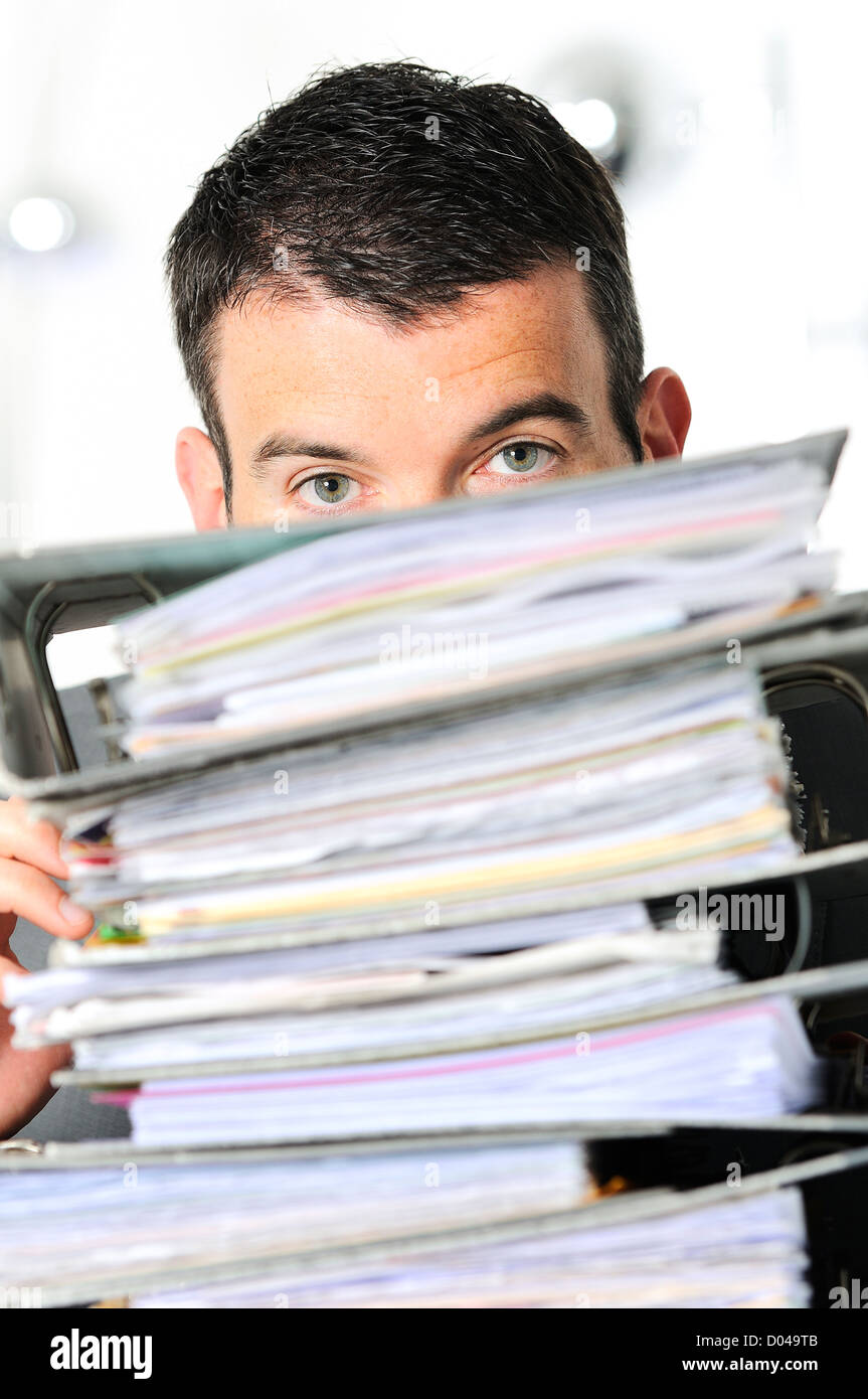 busy man hiding behind a stack of files Stock Photo - Alamy