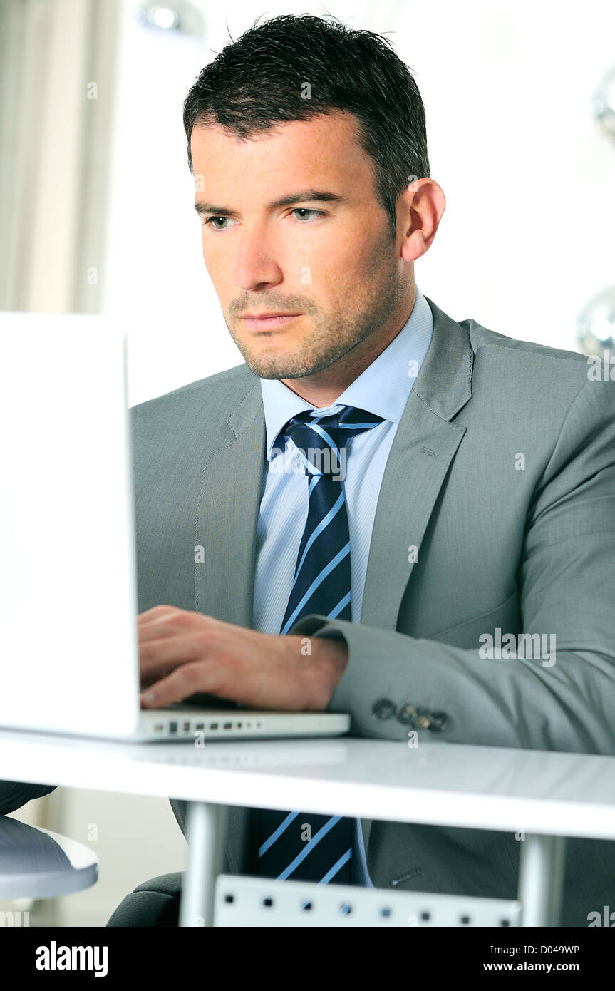An attractive business man is working on computer Stock Photo - Alamy