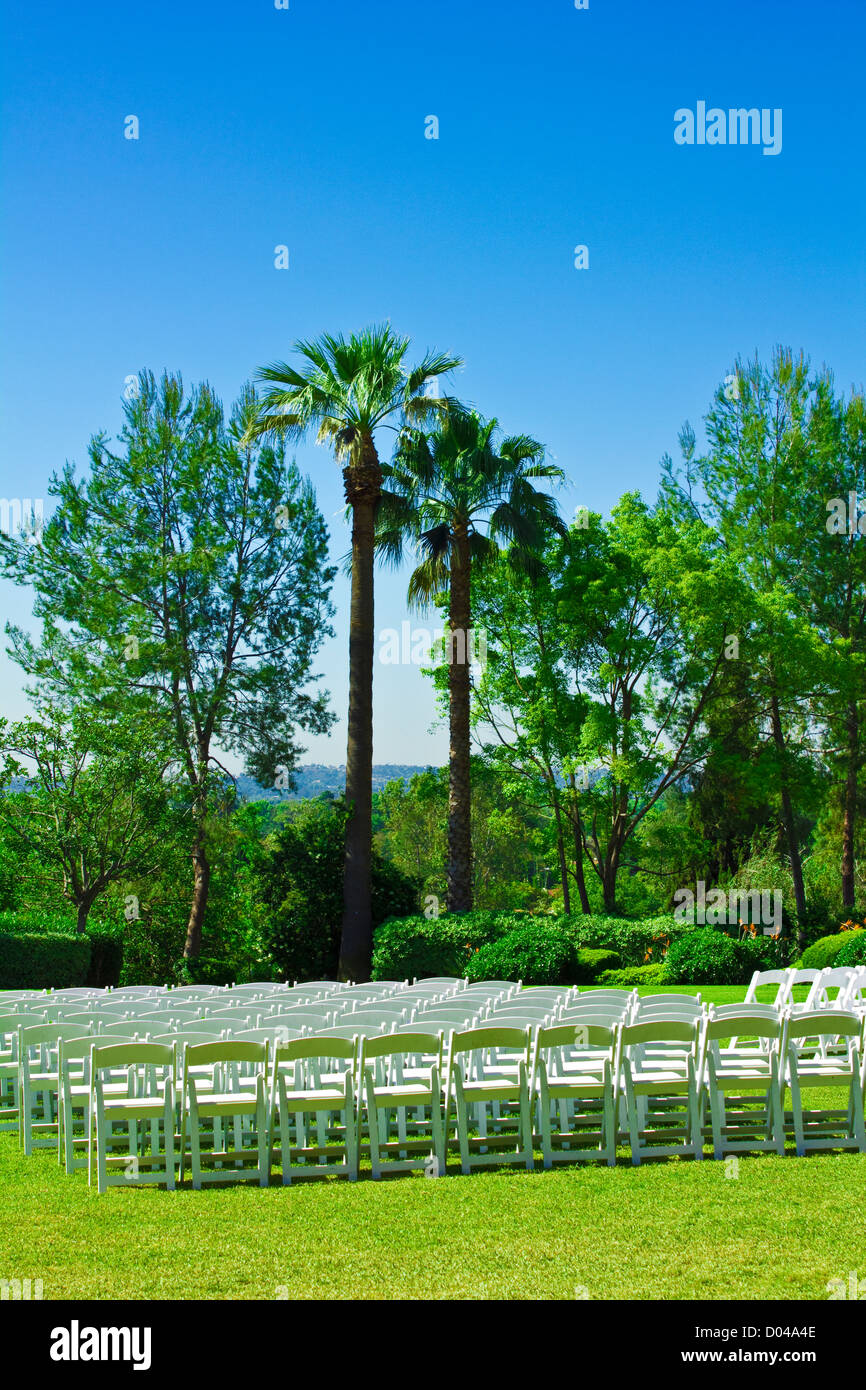 An image of a rows of white chairs in a park setting Stock Photo - Alamy