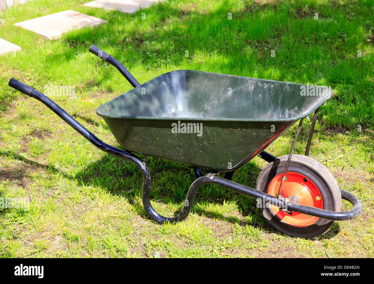 Wheelbarrow in the garden Stock Photo - Alamy