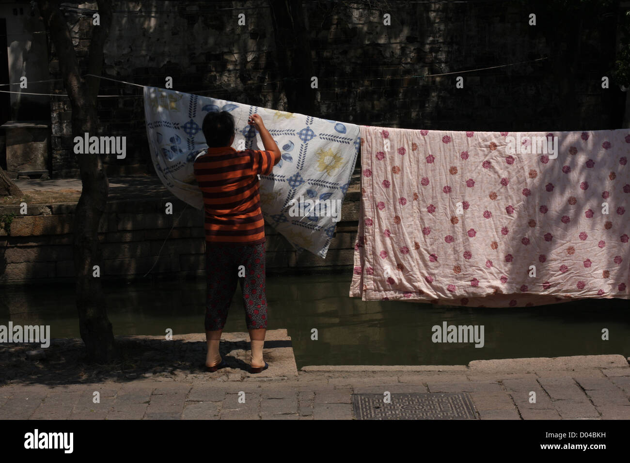 Mature woman hanging out washing hi-res stock photography and images ...