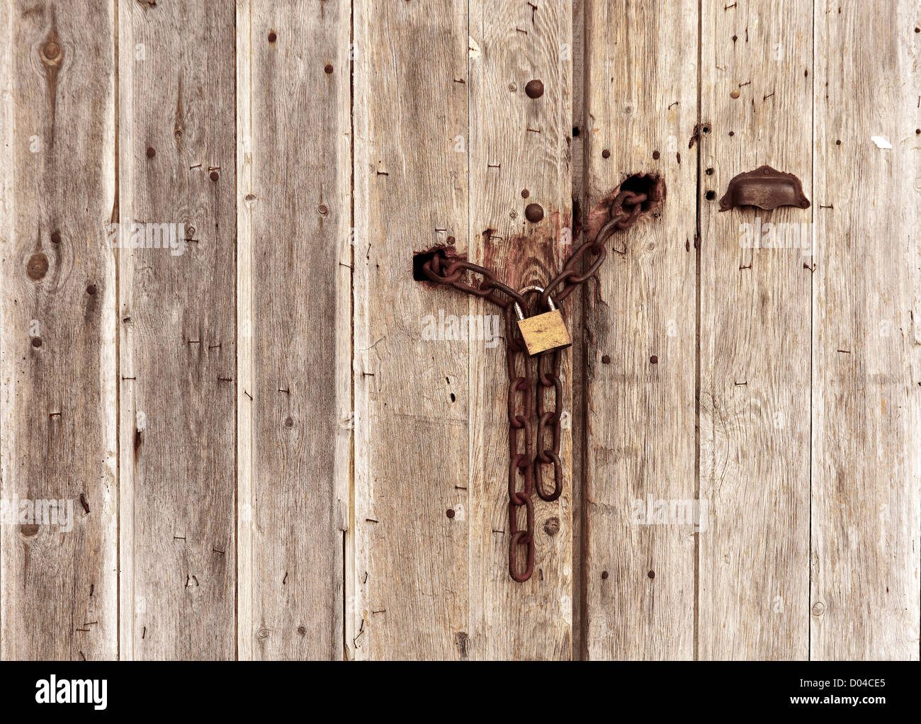 an old wooden door closed with a chain Stock Photo - Alamy