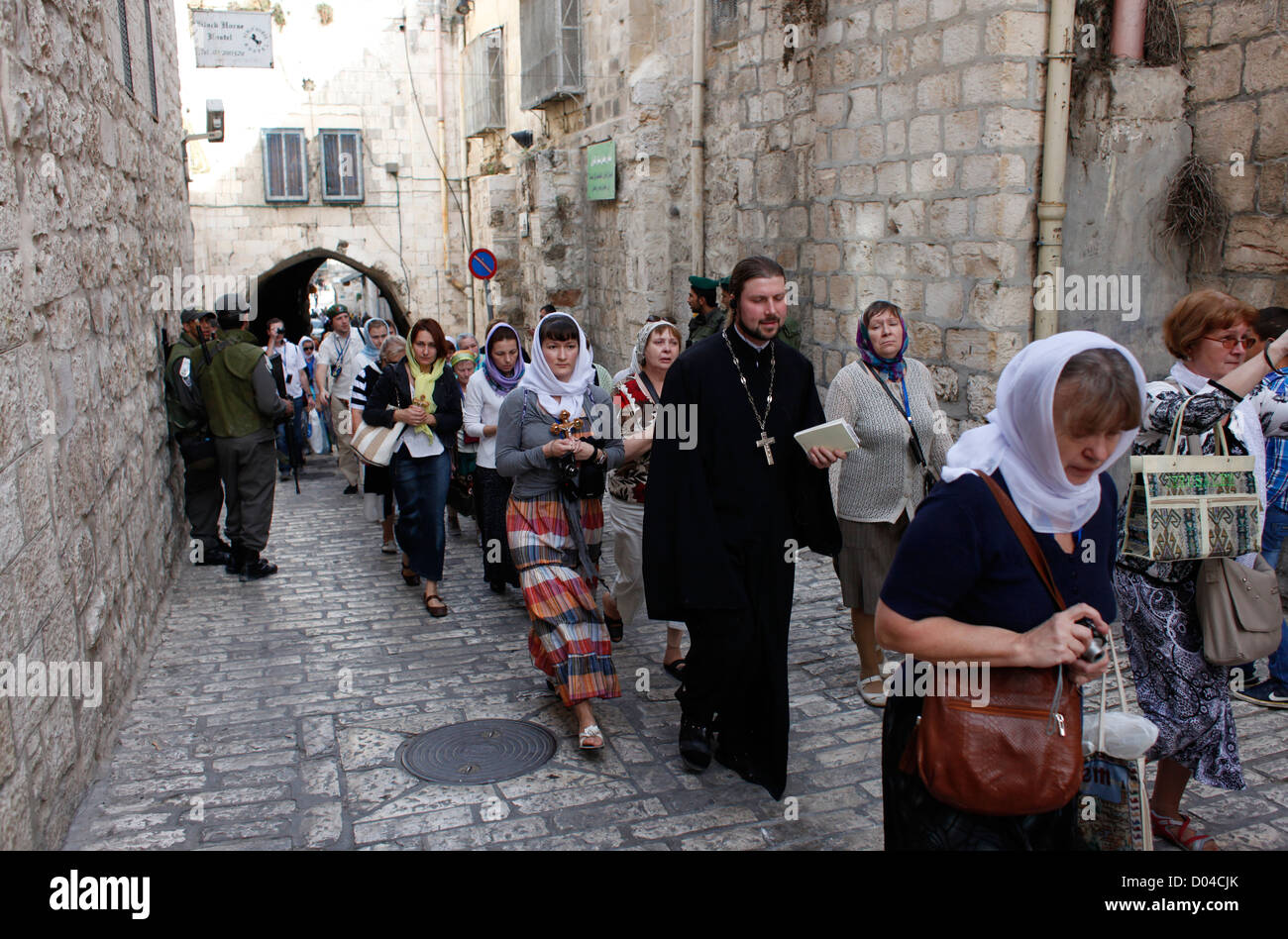 A group of Christian pilgrims walking along Via Dolorosa street ...