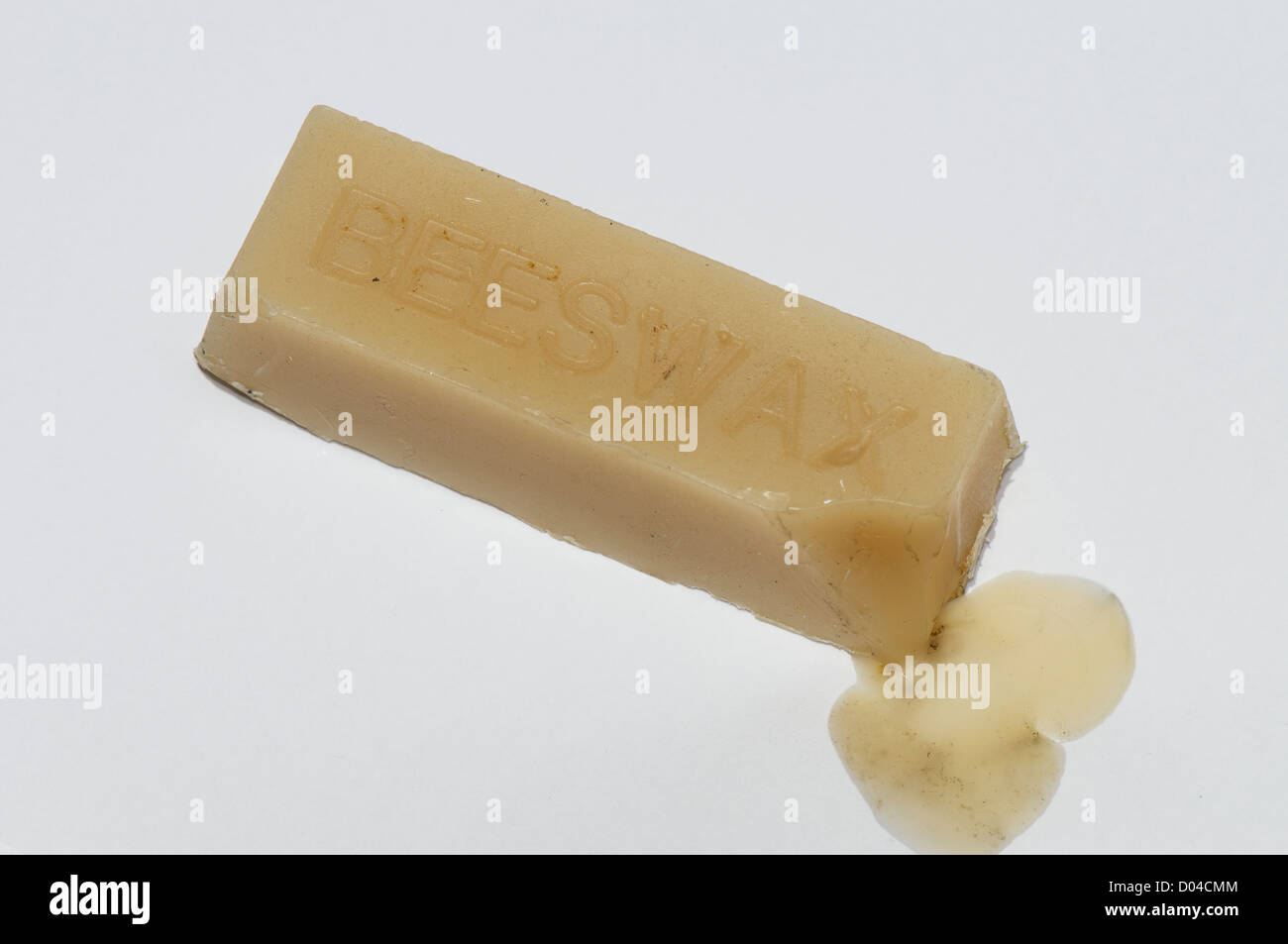 Bees wax block and melted puddle Stock Photo - Alamy
