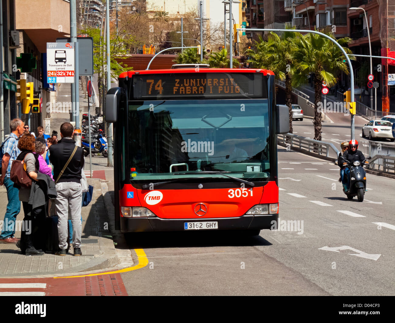 Single deck red Mercedes Benz bus at bus stop in Barcelona city centre ...