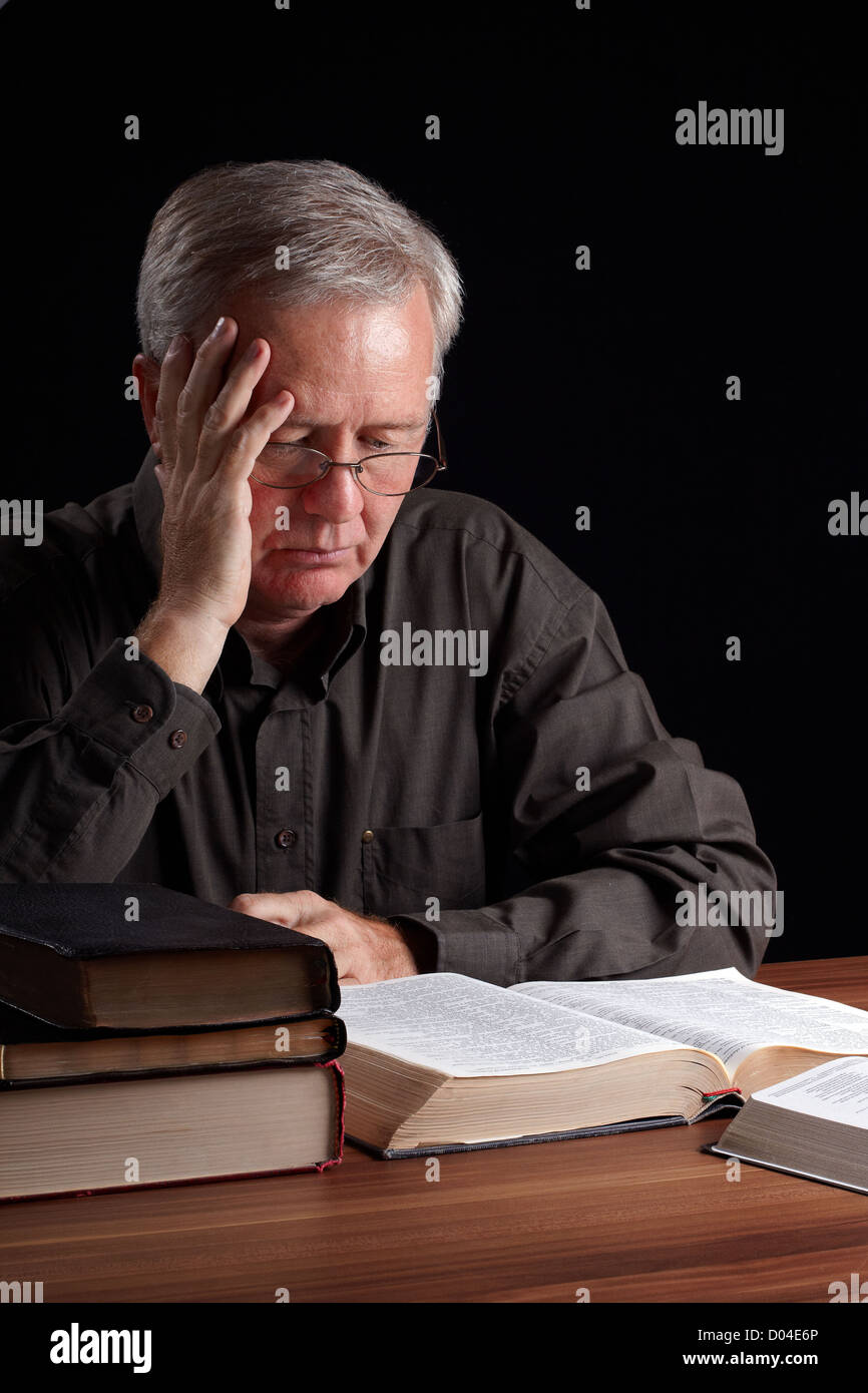 Senior pastor reading, meditating and searching spiritual light Stock ...