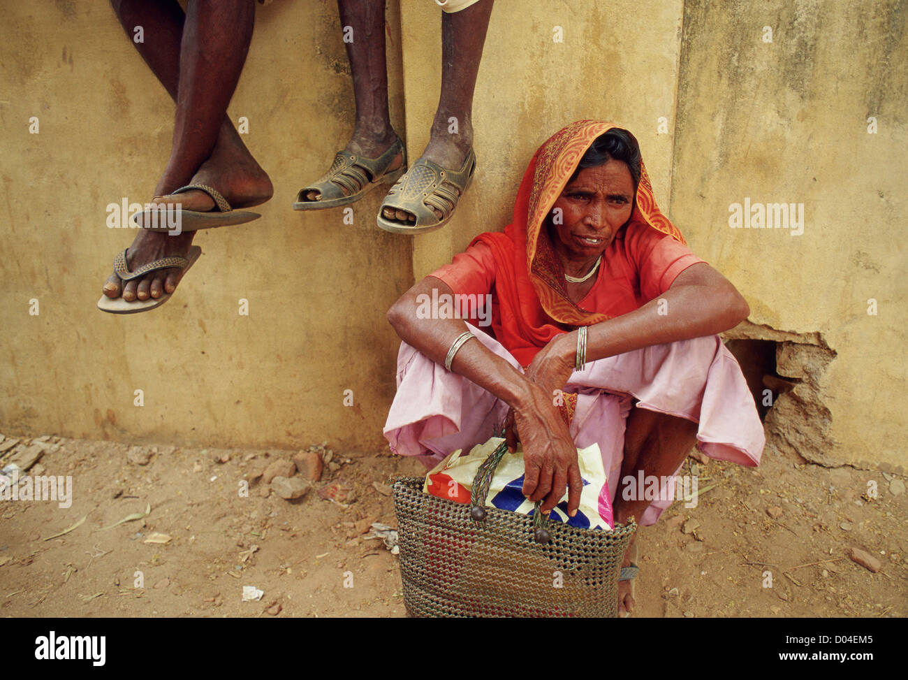 Poor tribal woman feeling sad. With other tribal people, she is waiting ...