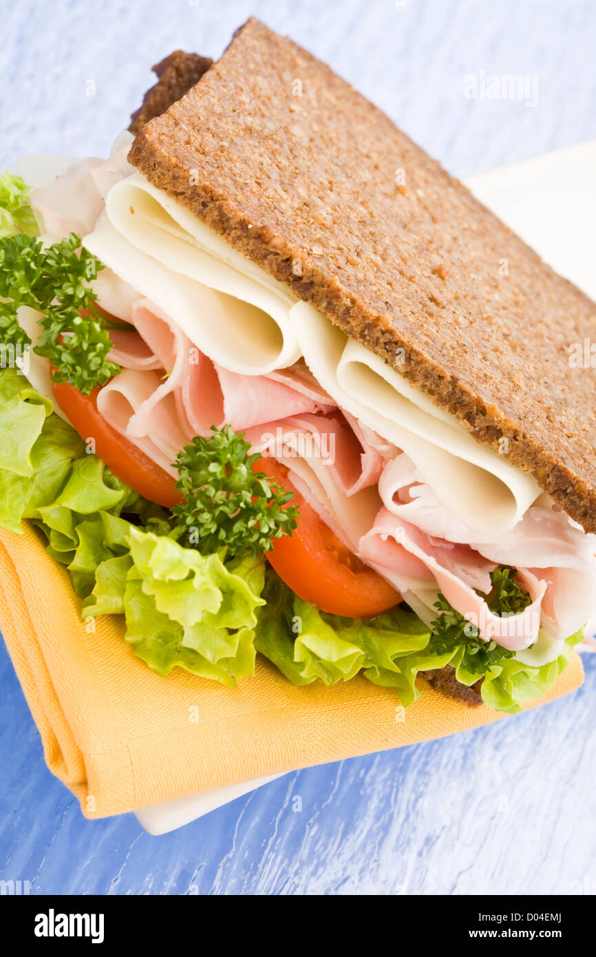 photo of delicious big cheese and ham sandwich with lettuce on blue ...