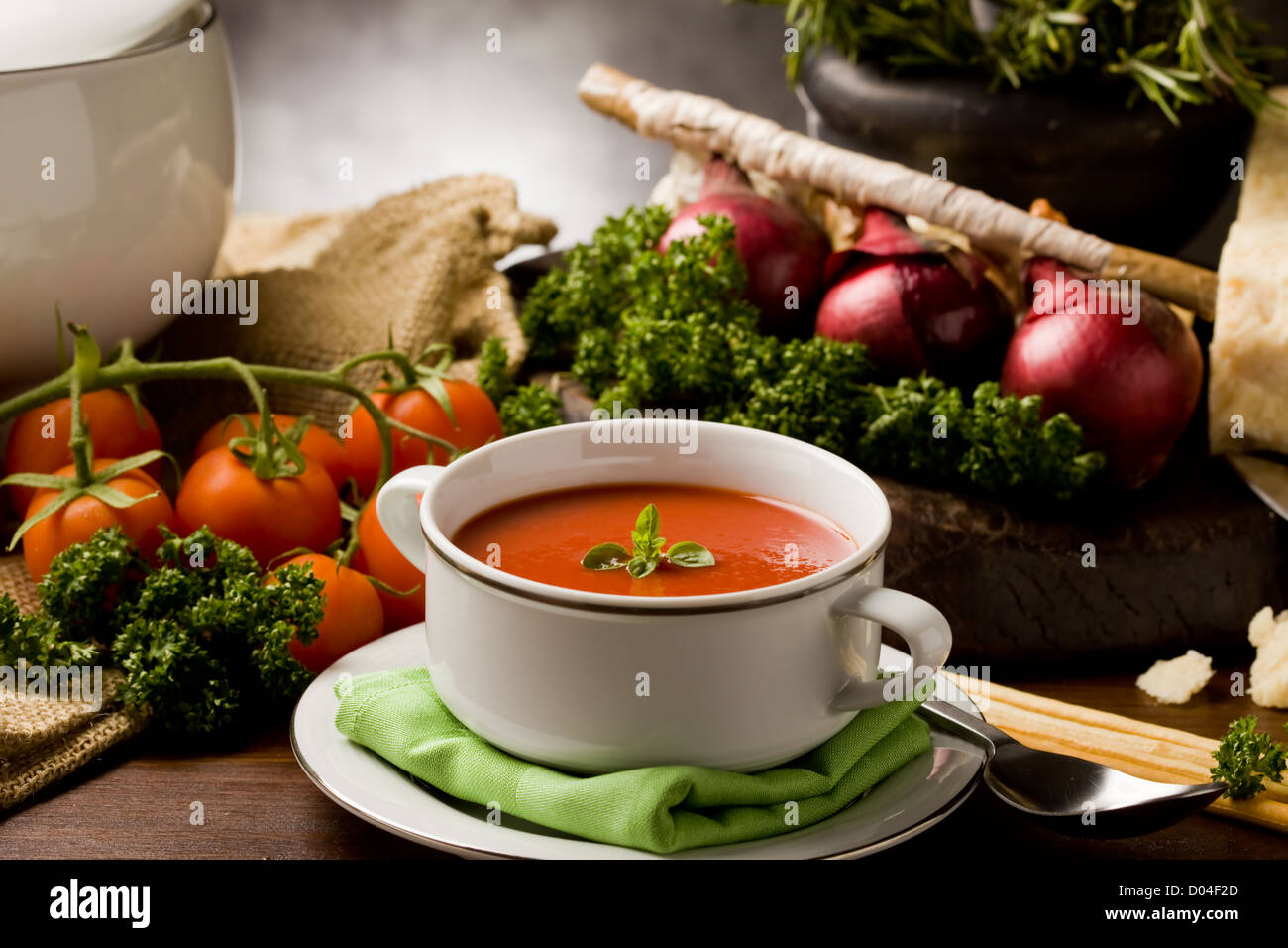 photo ofo delicious tomato soup with vegetables on wooden table Stock ...