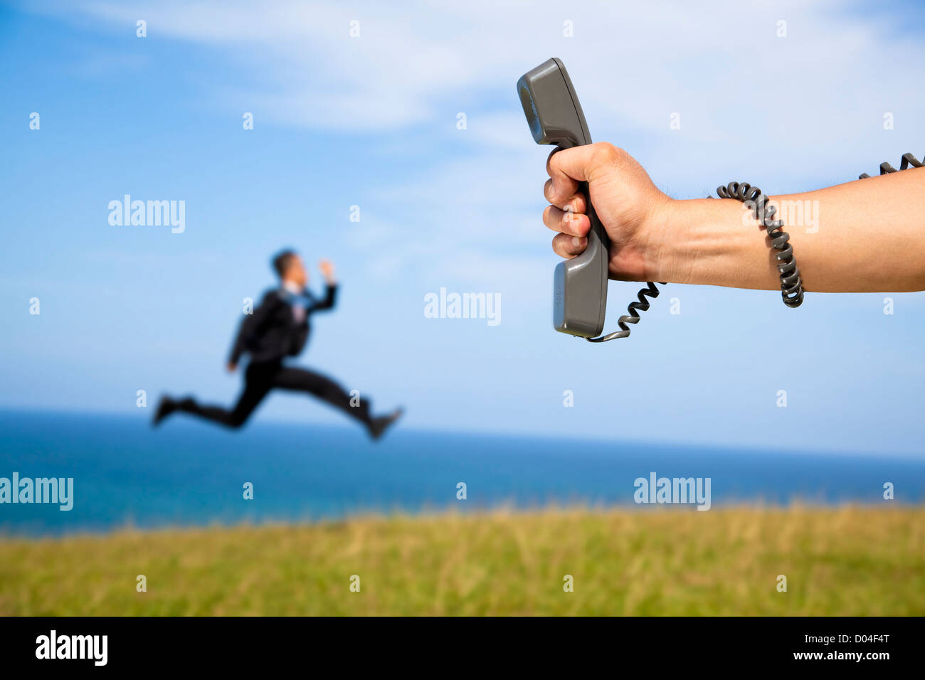 hand holding phone and running businessman Stock Photo - Alamy