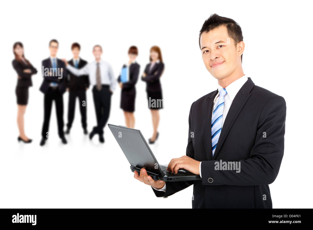 smiling businessman holding laptop and successful business team Stock ...