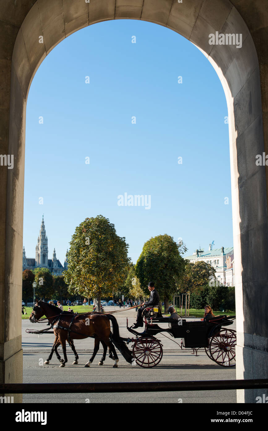 Traditional horses and carriage (also called Fiaker) passing the famous ...